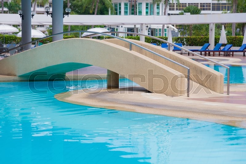 Stone bridge crossing on swimming pool. | Stock image | Colourbox
