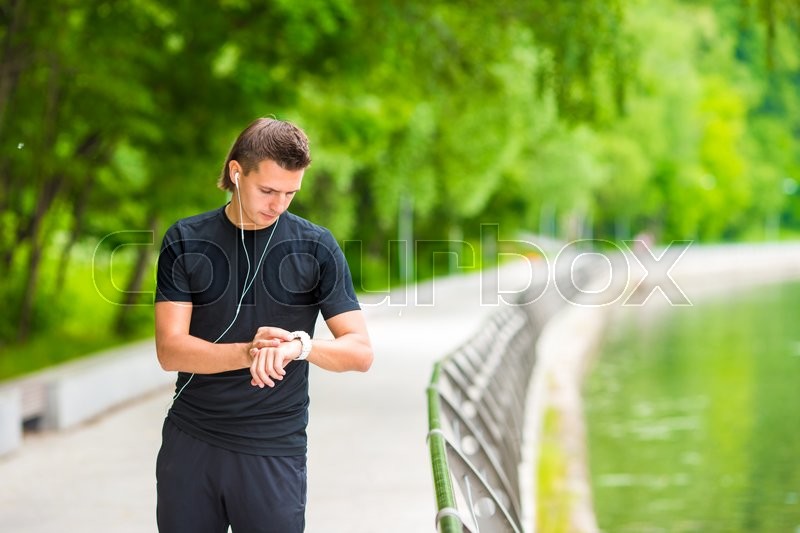 Runner looking at smart watch heart ... | Stock image | Colourbox
