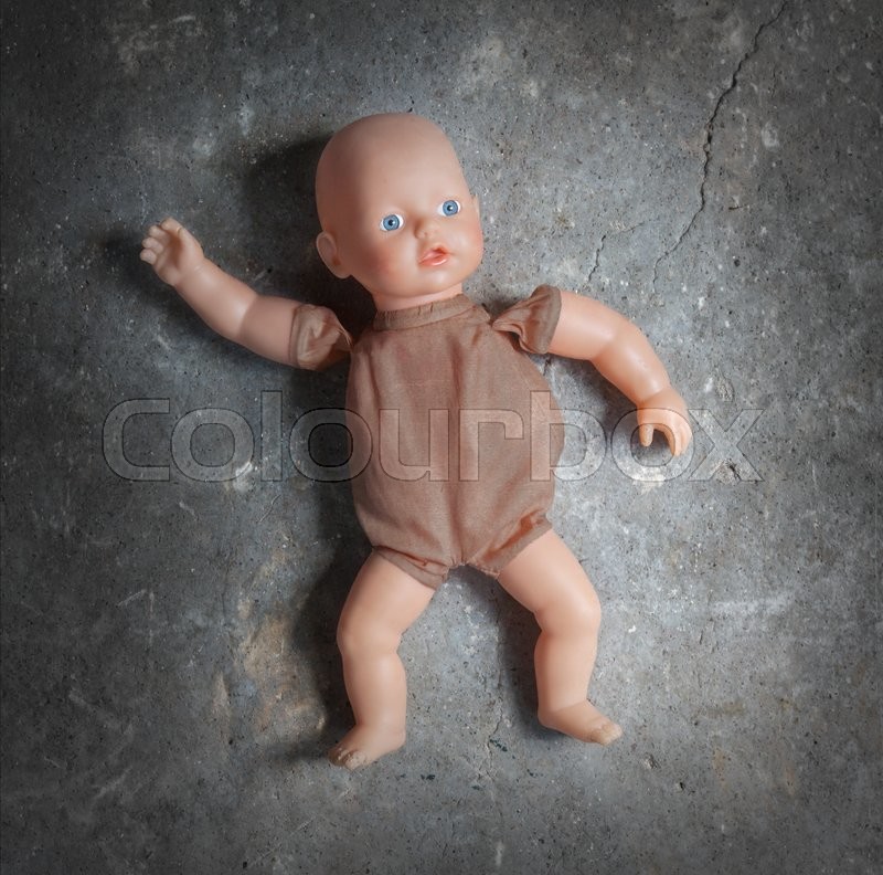Abandoned doll laying on a concrete ... | Stock image | Colourbox