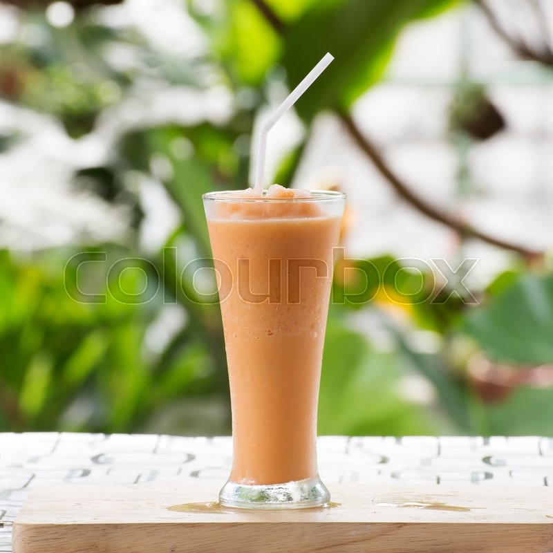 Glass of Thai Tea smoothie on the table | Stock image | Colourbox