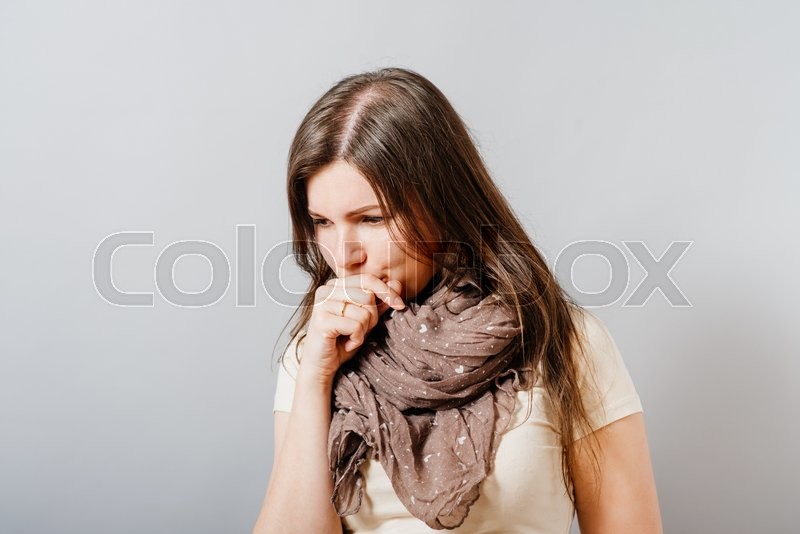 Young woman coughing. On a gray ... | Stock Photo | Colourbox