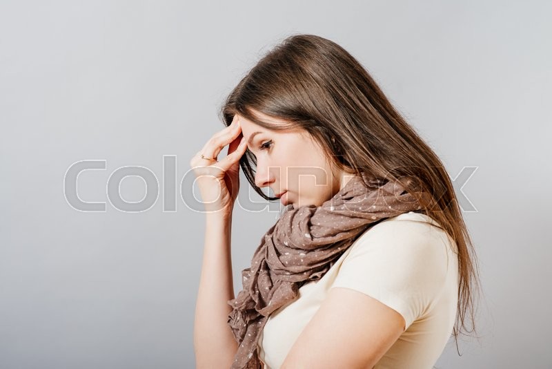 Young sad woman lowered her head and ... | Stock image | Colourbox