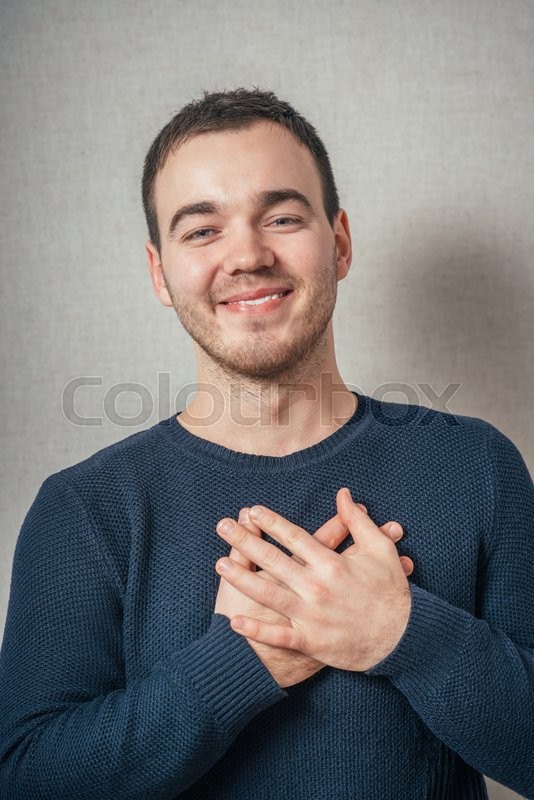 The man put his hands on his chest, the ... | Stock Photo | Colourbox