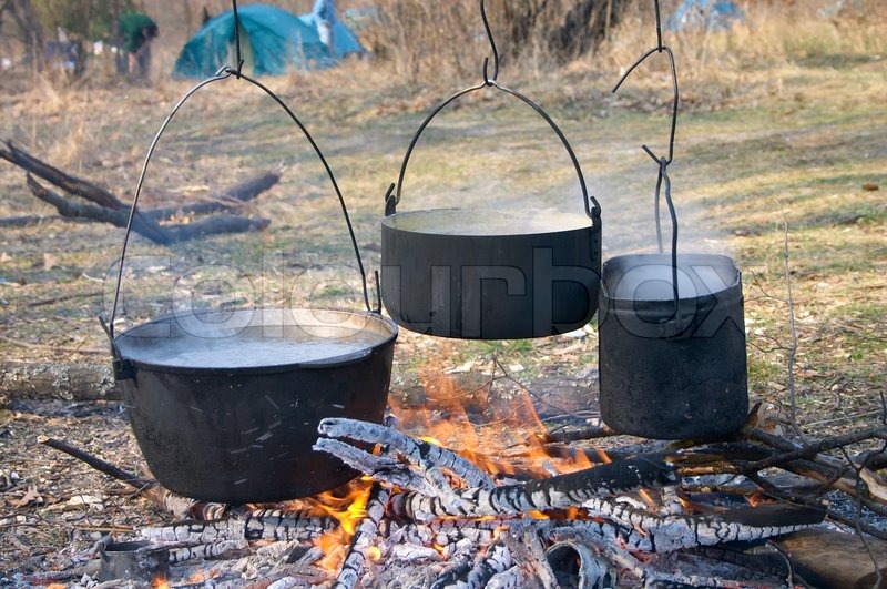 Boiled water in kettles above the fire | Stock image | Colourbox