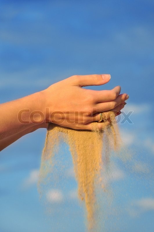 Sand falling through his hands against ... | Stock image | Colourbox