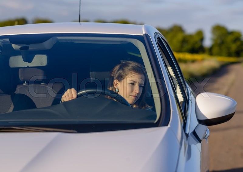 Female driver checking her side mirror ... | Stock image | Colourbox