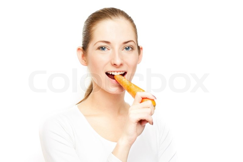 Young woman eating the carrot, over ... | Stock image | Colourbox