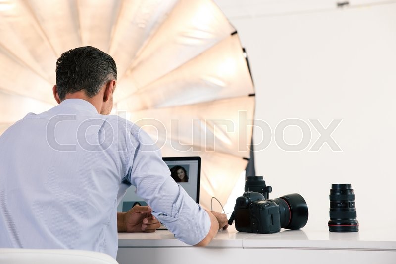 Back view portrait of photographer ... | Stock image | Colourbox