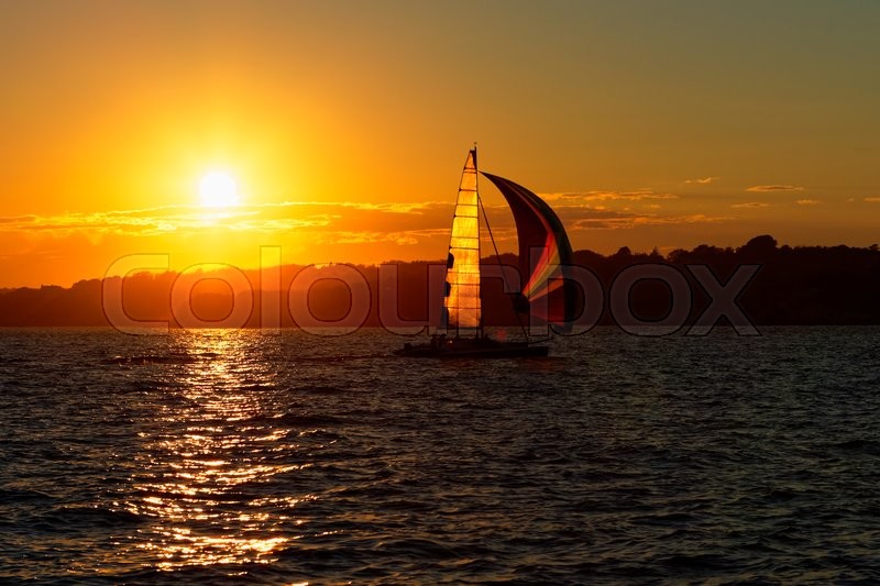 Sail boat at sunset on the ocean. | Stock image | Colourbox