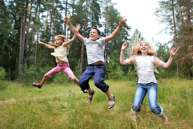 Children jump on lawn in summer forest ... | Stock image | Colourbox