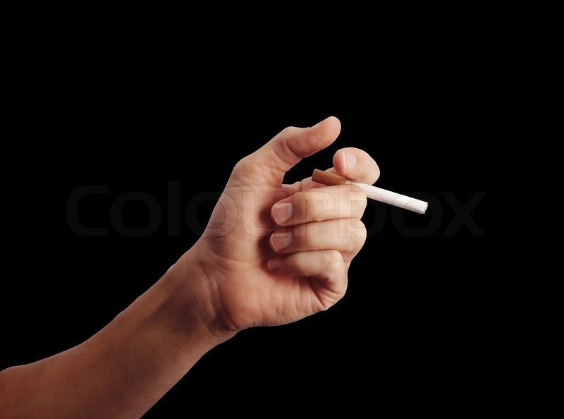 Man's hand with a cigarette over black ... | Stock image | Colourbox