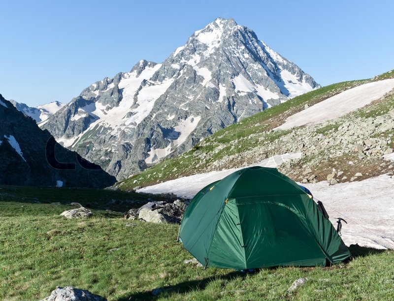 Green camping tent near high mountain, ... | Stock image | Colourbox