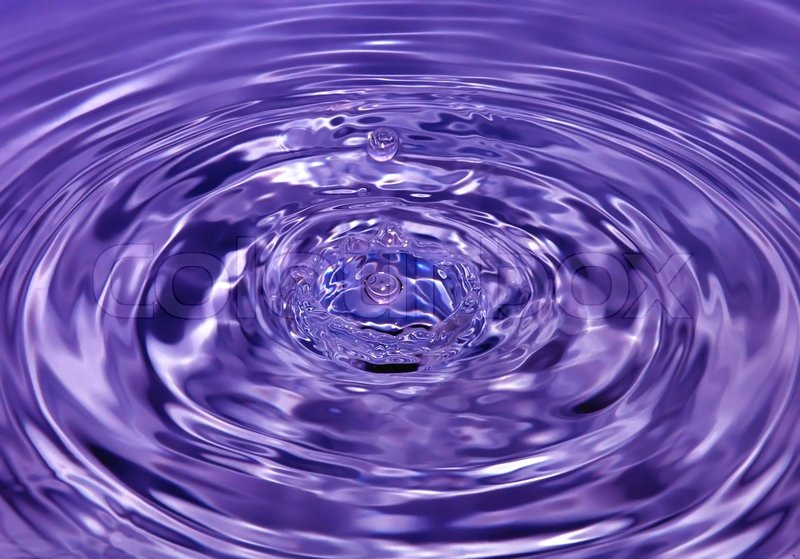 Drops fall in violet water and make ... | Stock Photo | Colourbox