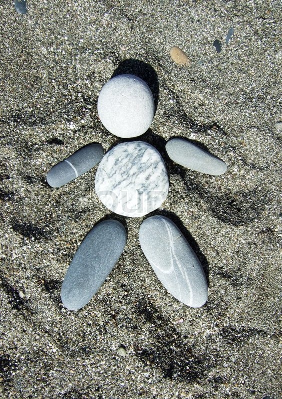 Pebble man on a sand | Stock image | Colourbox