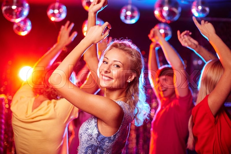 Joyful girl dancing in night club with ... | Stock image | Colourbox