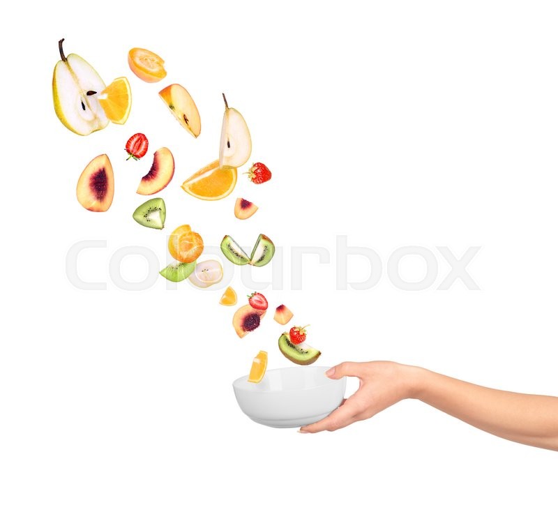 Falling fruit in a bowl. Isolated on ... | Stock image | Colourbox