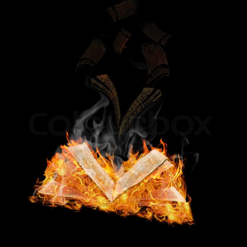 Open magic book in flame against black ... | Stock image | Colourbox