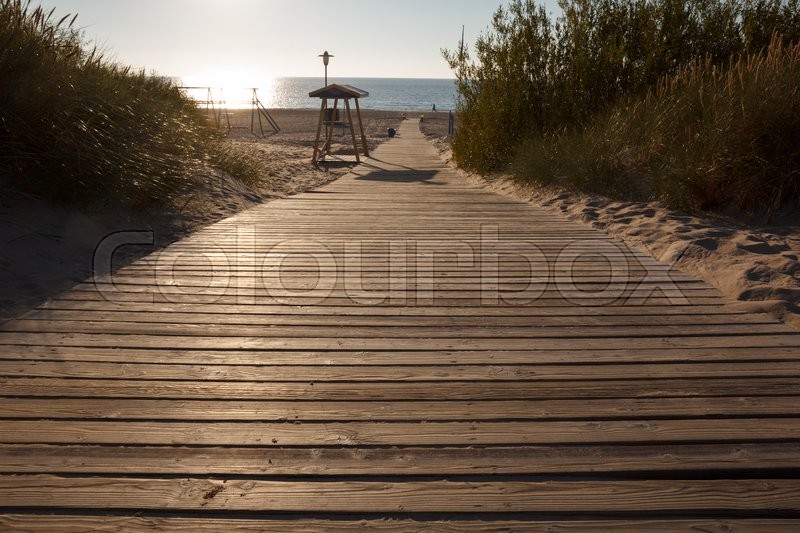 A wooden walkway leading to the beach | Stock image | Colourbox