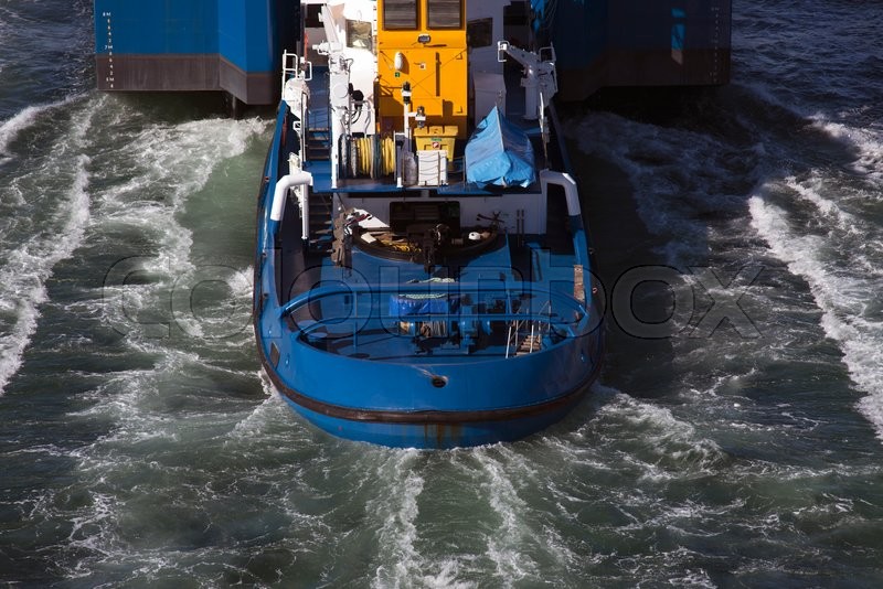 Top view of Tugboat pushing a heavy ... | Stock image | Colourbox