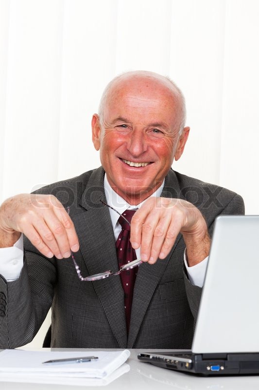A successful older businessman sits in ... | Stock image | Colourbox