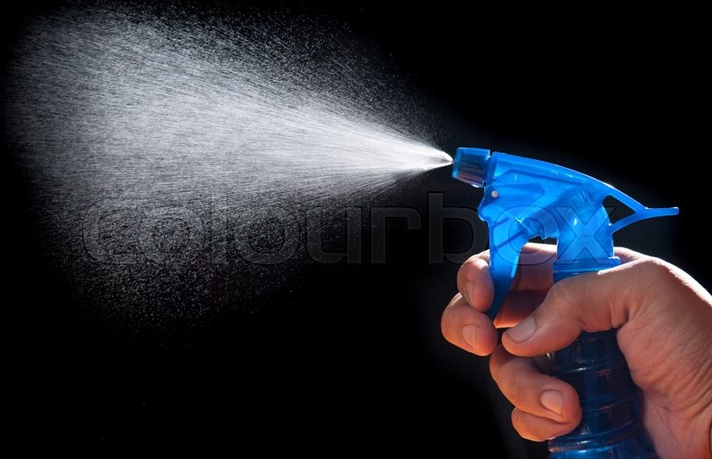 Liquid is sprayed from an atomizer | Stock image | Colourbox