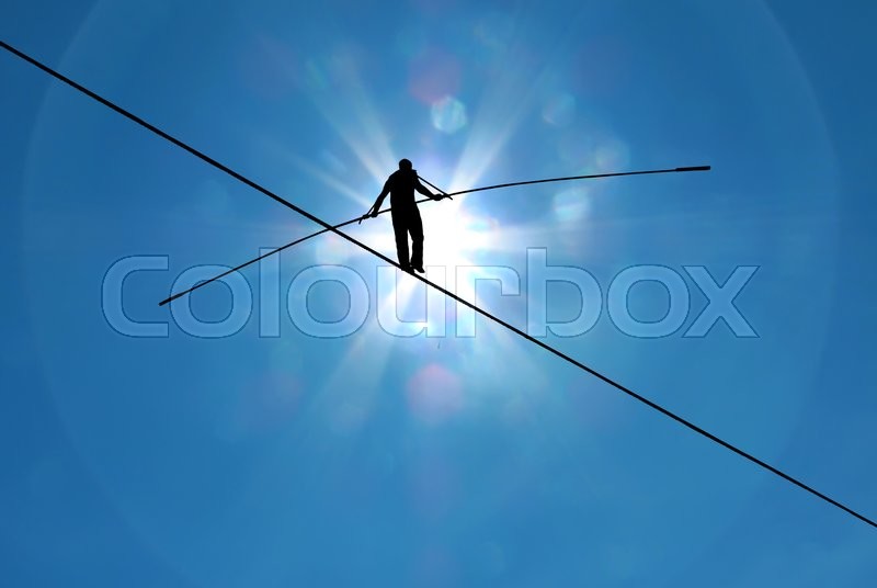 Tightrope walker balancing on the rope ... | Stock image | Colourbox