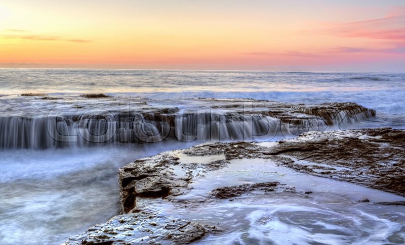 Flowing water over rocks and into the ... | Stock image | Colourbox