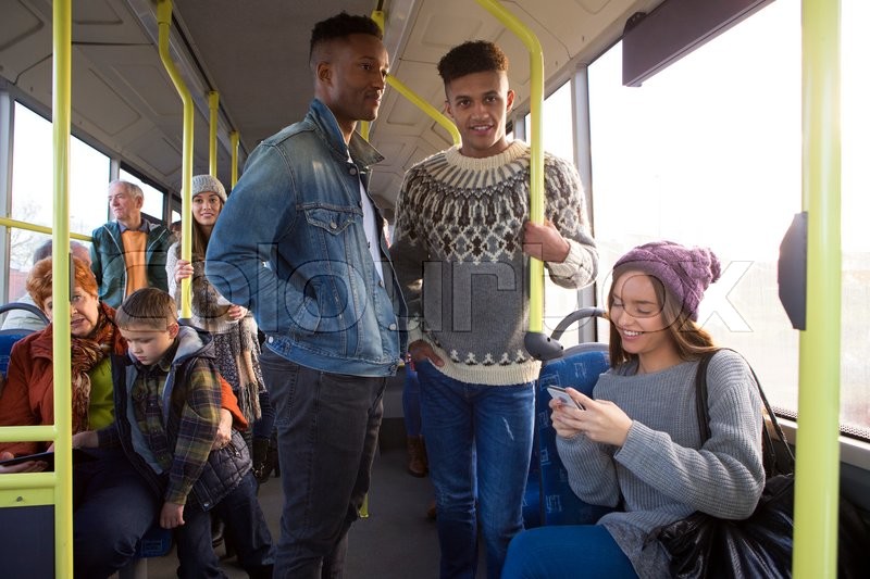 Two men are standing on a bus. There ... | Stock image | Colourbox