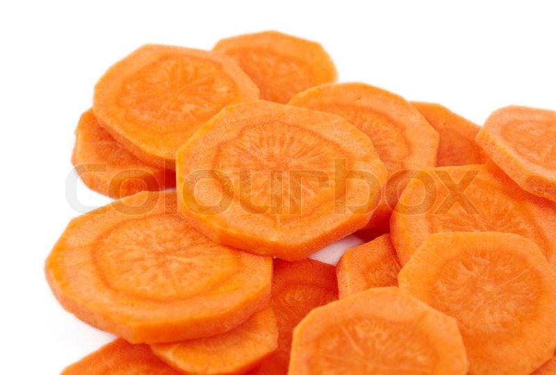 Carrots cut into circles on a white ... | Stock image | Colourbox