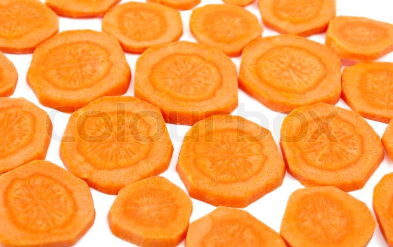 Carrots cut into circles on a white ... | Stock image | Colourbox