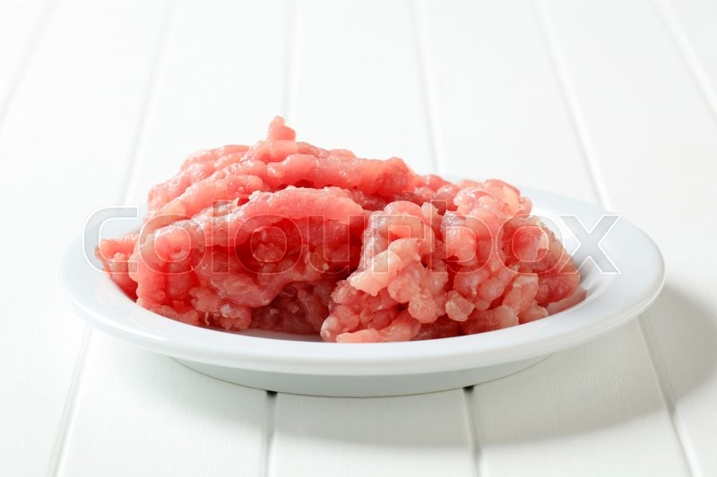 Raw minced meat on a plate isolated | Stock image | Colourbox