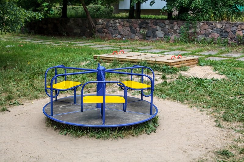Blue roundabout with yellow chairs in ... | Stock image | Colourbox