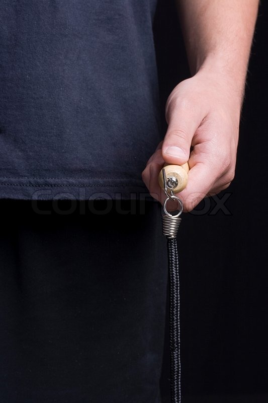 Human hand holding a jump rope on a ... | Stock image | Colourbox
