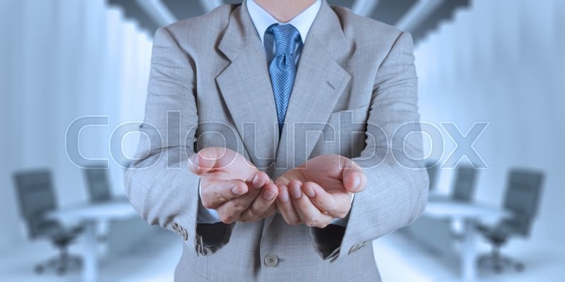 Business man with an open hand as ... | Stock image | Colourbox
