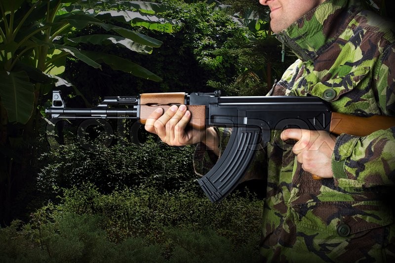 Soldier with rifle AK-47 in jungle | Stock image | Colourbox