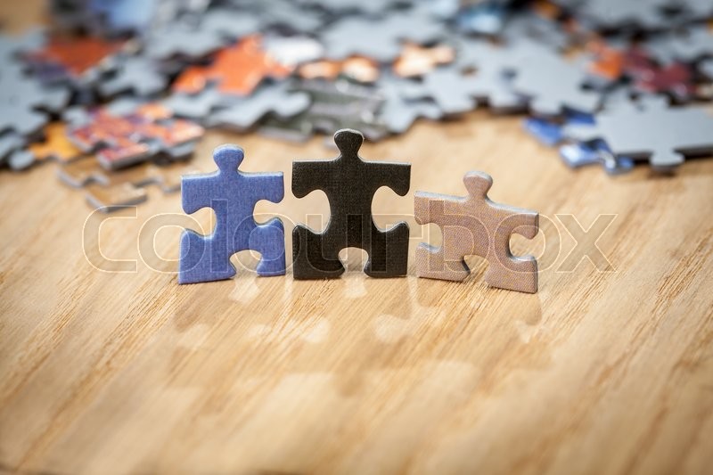 Three color jigsaw puzzle pieces on ... | Stock Photo | Colourbox