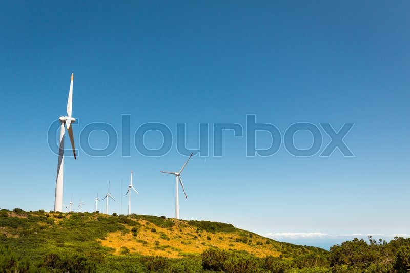 Windmills in the green valley against ... | Stock image | Colourbox