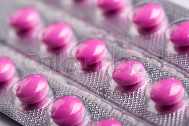 Close up of pink pills in plastic pack | Stock image | Colourbox