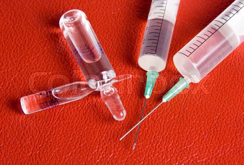 Medicines and open syringes on red ... | Stock image | Colourbox