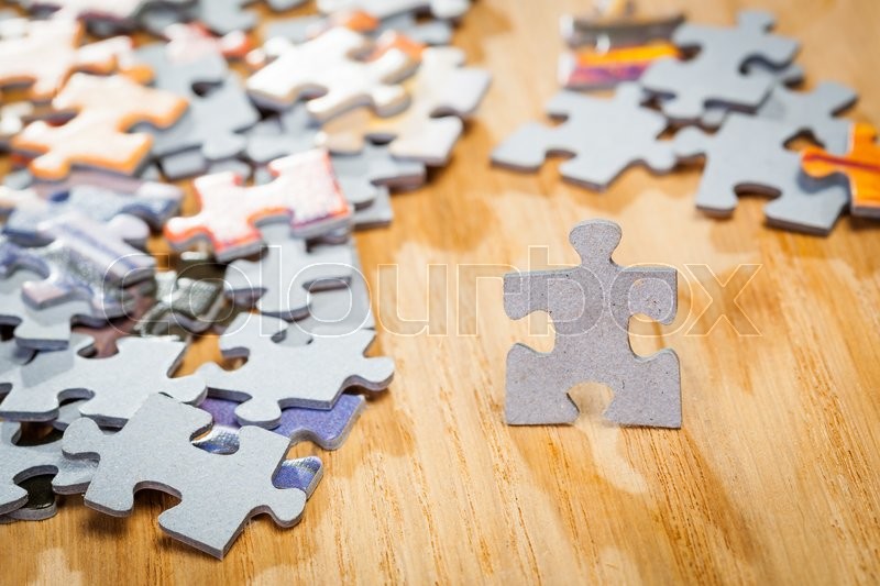 Paper jigsaw puzzle by pieces on a ... | Stock Photo | Colourbox
