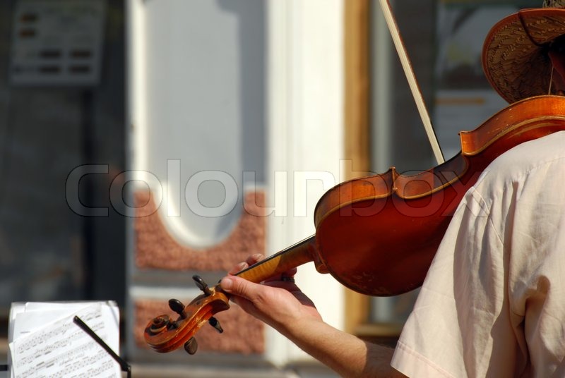 Street violinist playing a violin with ... | Stock image | Colourbox