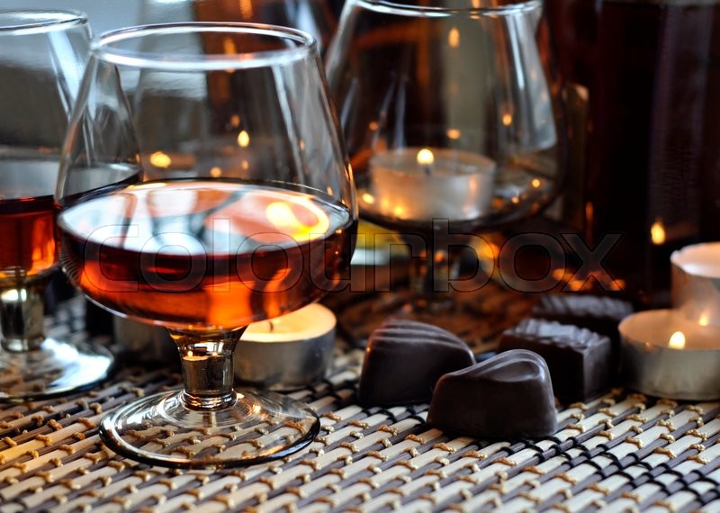 A glass of brandy, chocolate sweets and ... | Stock Photo | Colourbox