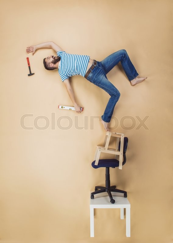 Handyman falling dangerously from a ... | Stock image | Colourbox