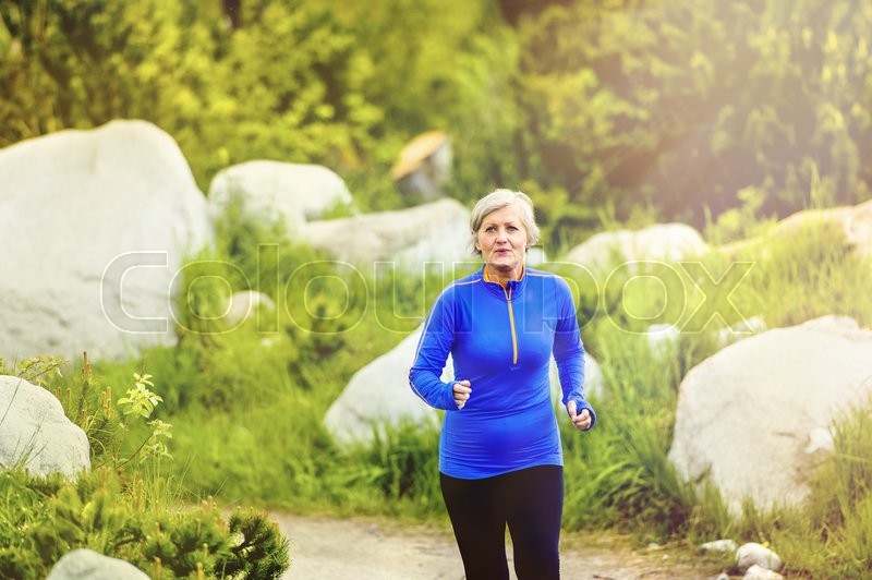 Senior woman jogging in beautiful ... | Stock image | Colourbox