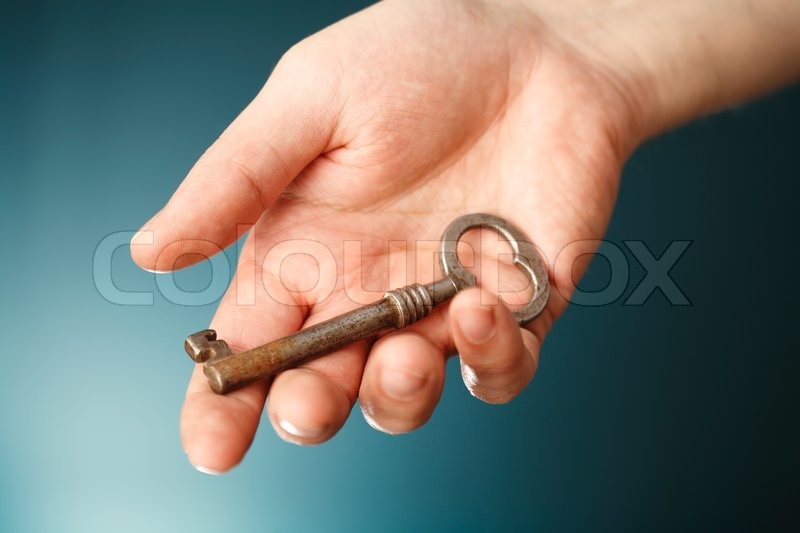 A Hand holding an old key. | Stock image | Colourbox