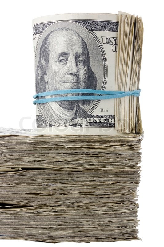 Roll of American money on a stack of ... | Stock image | Colourbox