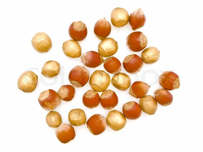 Golden hazelnuts over white background | Stock image | Colourbox