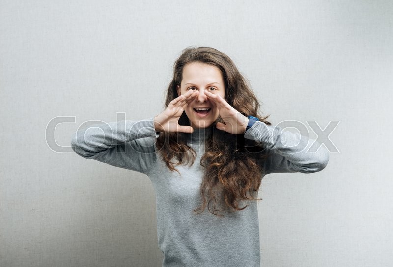 Woman shouting with her hands around ... | Stock image | Colourbox