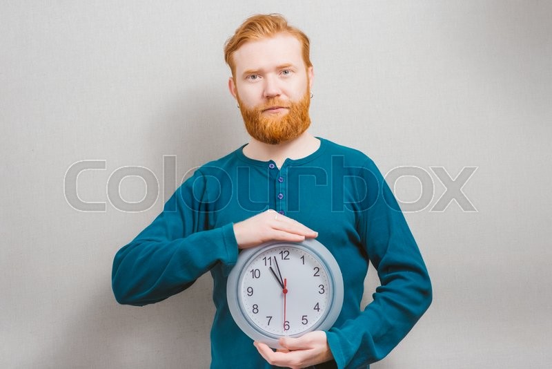 Businessman holding large clock | Stock image | Colourbox