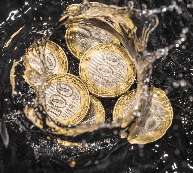 Coins in water splashes on a black ... | Stock image | Colourbox